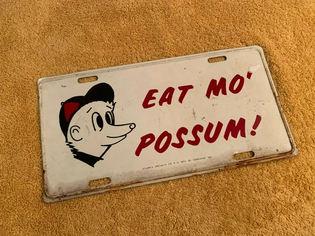 VINTAGE EAT MO' POSSUM! Booster license plate tag EAT MORE POSSUM 1960s ...