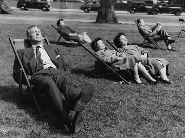 ACTOR GARY COOPER relaxing in a deck chair, wearing a suit and tie- Old ...