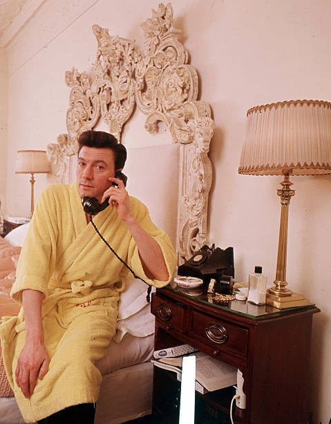 ACTOR LAURENCE HARVEY is talking on the telephone in his bedroom Old ...