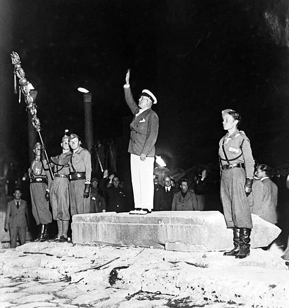BENITO MUSSOLINI SALUTING and surrounded by young fascists in Ital ...