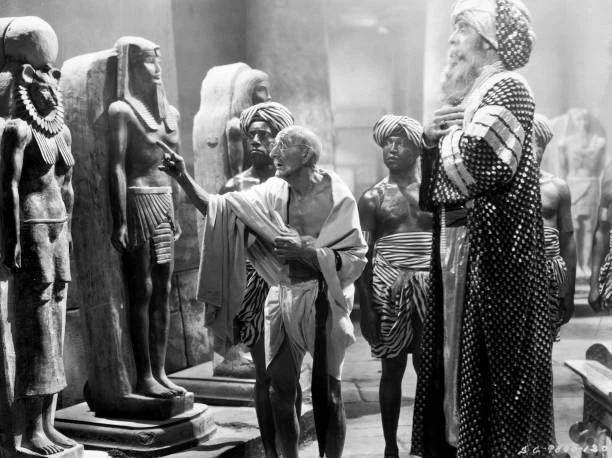 RELIGIOUS SEER POINTS with wonder to a carved sarcophagus withi- 1925 ...