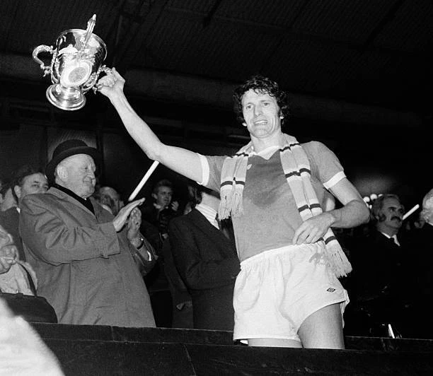 MANCHESTER CITY CAPTAIN Mike Doyle holds the League Cup trophy afte ...