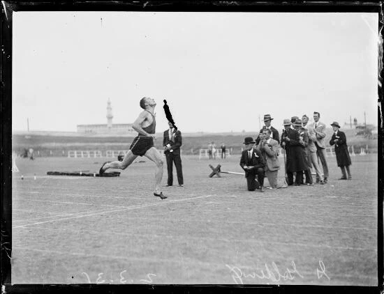 ATHLETE GEORGE GOLDING crossing finish line a track race, NSW, 2 Ma ...