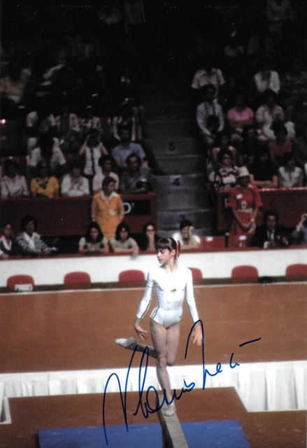 NADIA COMANECI STANDING on one foot during routine in montreal signed ...
