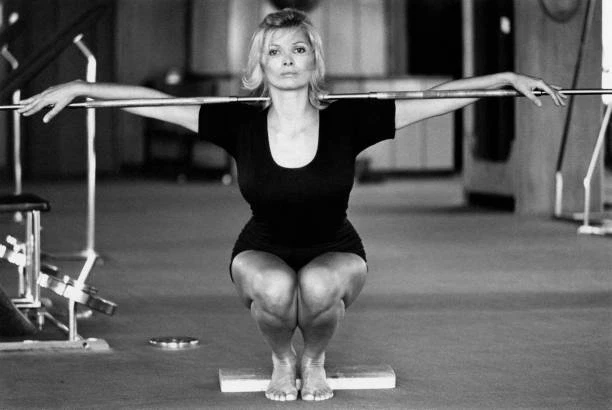 ITALIAN ACTRESS SCILLA Gabel working out with a stick in a gym Ro- 1970 ...