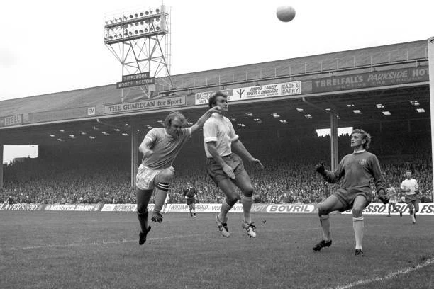 LEEDS UNITED DEFENDER Terry Cooper clears the ball away from M- 1971 ...