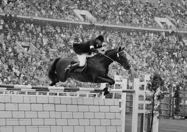 GRAEME HANSEN NEW Zealand riding Saba Sam jumping a wall during- 1964 ...