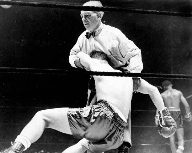 REFEREE BILLY CAVANAGH lifts Ruben Shank to his feet after fourth ...