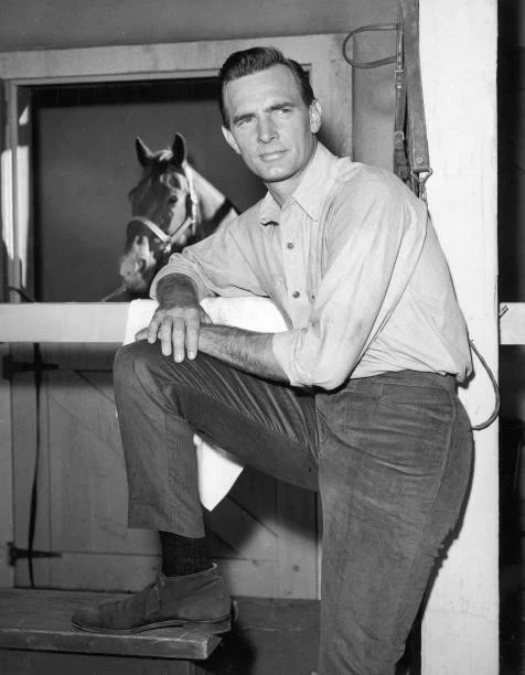 ACTOR DENNIS WEAVER propping his foot on top of a bench and lea - 1965 ...