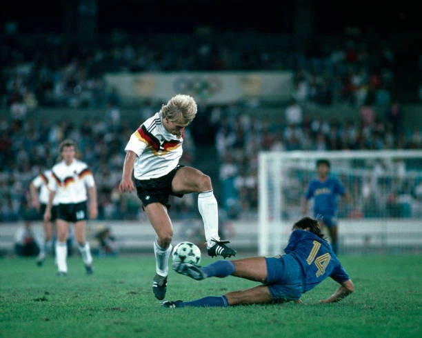 JURGEN KLINSMANN OF West Germany is tackled by Luiz Carlos Winck o- Old ...