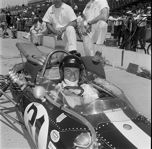 DAN GURNEY SITS in his Ford powered Eagle 201 in pit lane RACING OLD ...