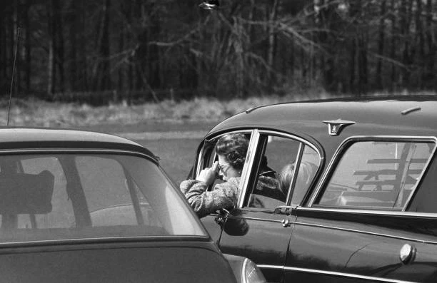 QUEEN ELIZABETH II leans out of her car to photograph her daug- 1972 ...