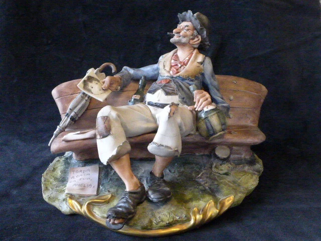 A DETAILED CAPODIMONTE STYLE TABLEAU OF SAD TRAMP ON BENCH by W ...