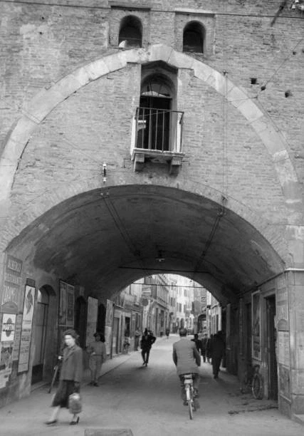 PEOPLE PASSING UNDER an arch giving access narrow alley Padua Apri- Old ...