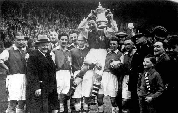 ARSENAL CAPTAIN ALEX James shows off the FA Cup as he is held up b- Old ...