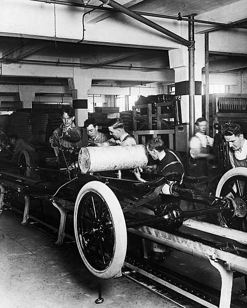MEN PUTTING TOGETHER Autos On The Ford Factory Assembly Line. The Wh ...