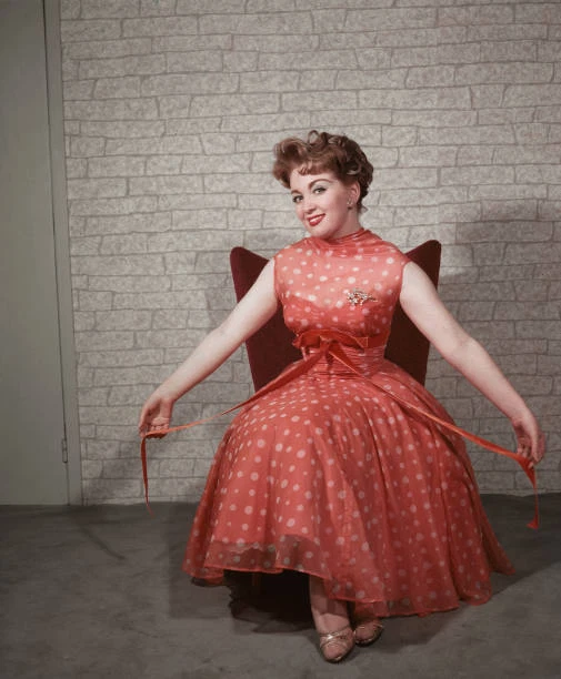 BRITISH SINGER MARION Ryan sits wearing a red dress with white - 1955 ...