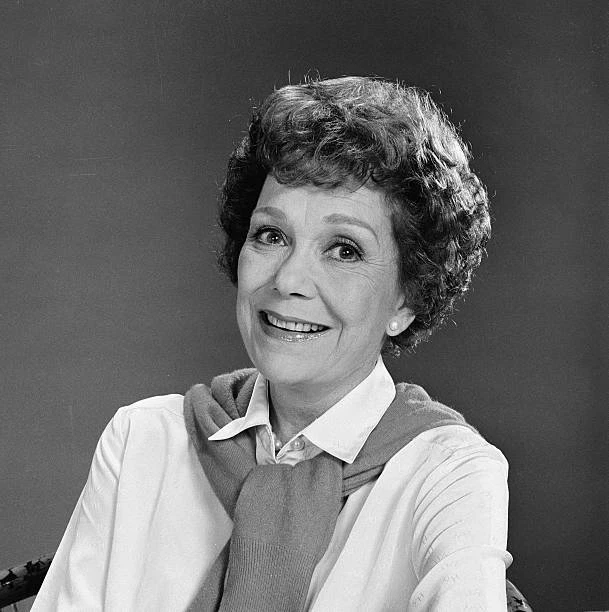 JANE WYMAN SMILES for an informal portrait with a sweater tied ove- Old ...