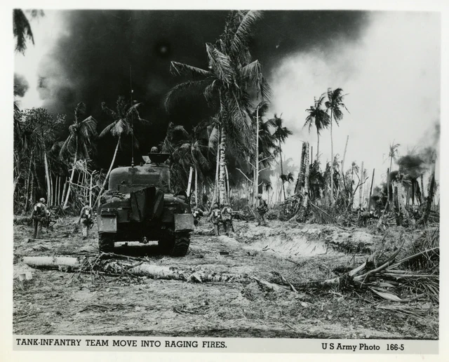 US ARMY TANK-INFANTRY team advancing towards jungle fire Marshall Is ...