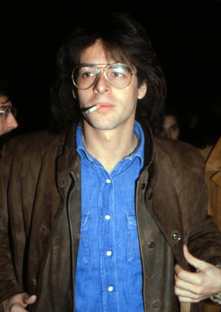 ITALIAN SINGER CLAUDIO Baglioni smoking a cigarette with a lea- 1982 ...