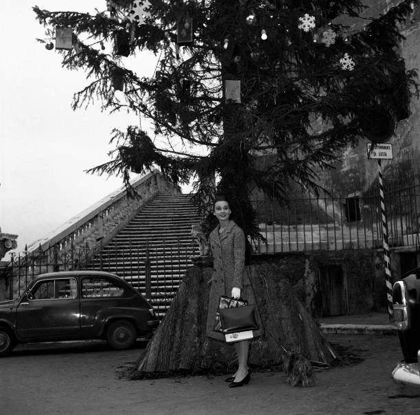 BRITISH ACTRESS AUDREY Hepburn standing front big tree decorated f- Old ...