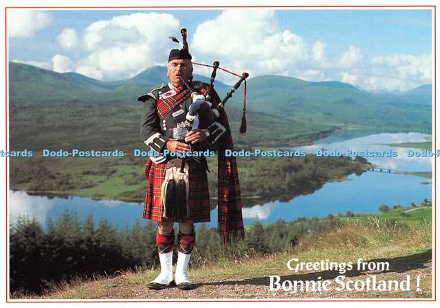 D078039 GREETINGS FROM Bonnie Scotland. A Scottish Piper above Loch ...