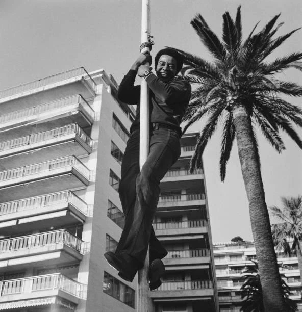 AMERICAN SINGER BILL Withers hangs from a pole during the Midem sh- Old ...