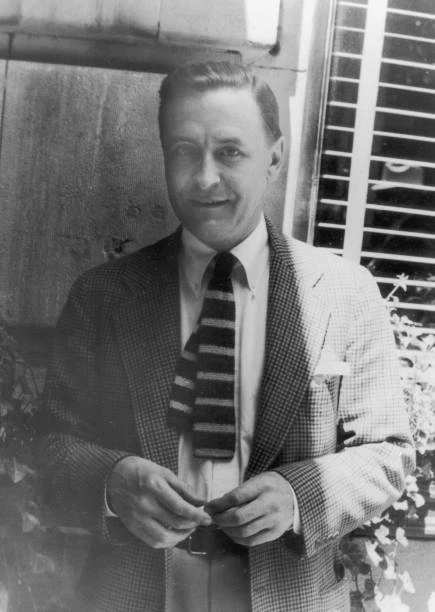 PORTRAIT OF AMERICAN author F Scott Fitzgerald smiling while st- 1937 ...