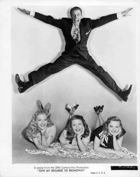 DAN DAILEY JUMPING over unidentified actresses a scene film Give M- Old ...