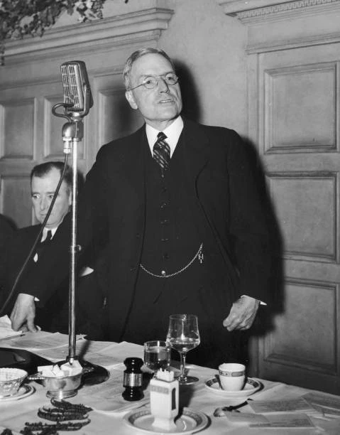 AMERICAN PHILANTHROPIST JOHN D Rockefeller Jr stands behind a tabl ...