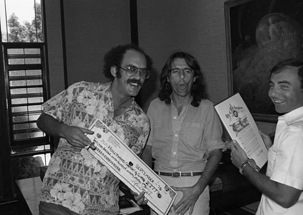 MANAGER SHEP GORDON and musician Alice Cooper hold a check made out Old ...