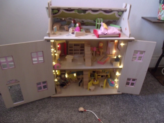 DOLLS HOUSE. MANY items of furniture. Complete with family. Lights up ...