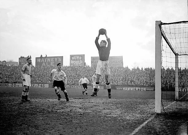 MANCHESTER CITY GOALKEEPER Frank Swift catches a cross watched by- Old ...