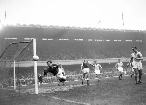 ASTON VILLA GOALKEEPER Nigel Sims dives towards a shot from Ar - 1958 ...