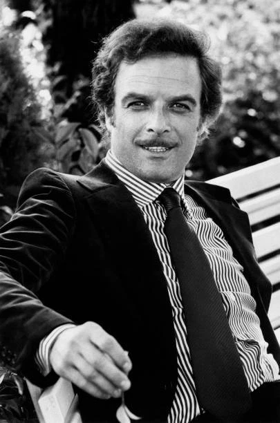 ITALIAN ACTOR GIANNI Garko posing smiling seated on a bench Rome - 1970 ...