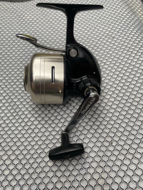 VINTAGE OLYMPIC ONE-TOUCH fishing reel. It is a close-faced spinning ...