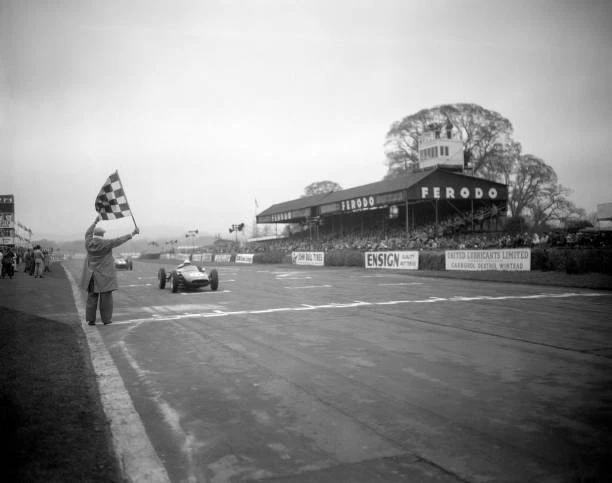 JOHN SURTEES CURRENT World motorcycle champion taking chequere- 1961 ...