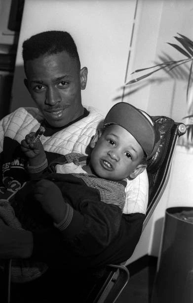 RAPPER MC SHAN poses for a portrait with his son, Little Shan, on - Old ...