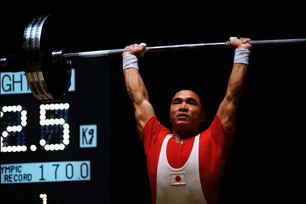 MASASHI OUCHI OF Japan Competes In The Weightlifting Men's Midd 1964 ...