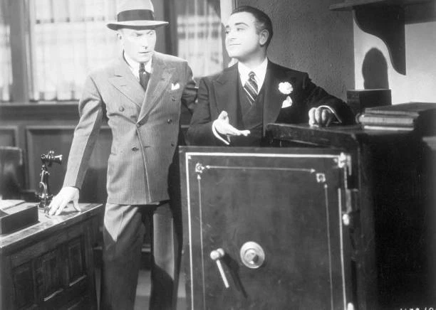 WILLIAM DEMAREST AND Akim Tamiroff inspect the contents of a sa- 1937 ...