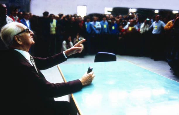 ITALIAN ENGINEER, TYCOON and racing driver Enzo Ferrari talking to ...