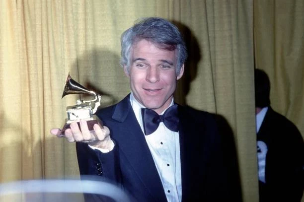 COMEDIAN STEVE MARTIN holds up the Grammy that he won for his album Old ...