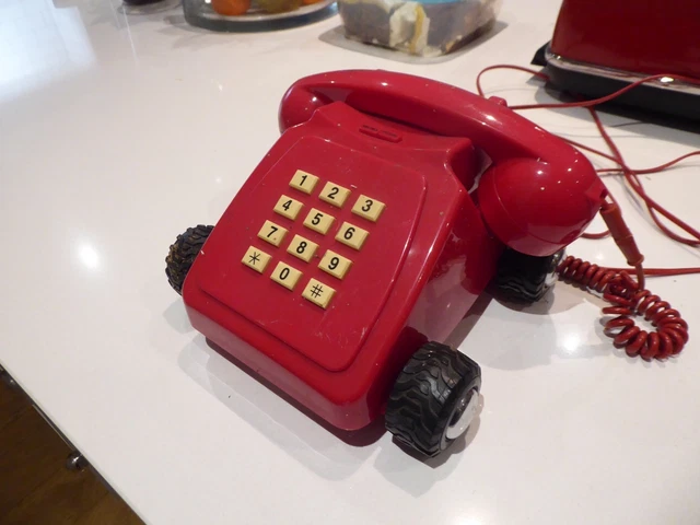 DIRECT LINE ADVERTISING Red Push-Button Telephone With Wheels Believed ...