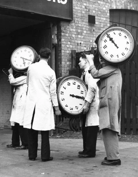 WORKERS CARRY LARGE electric clocks into a car works at Cricklewood Old ...