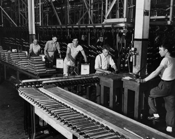 MUNITIONS WORKERS BESIDE steady flow shells production line a Gene Old ...
