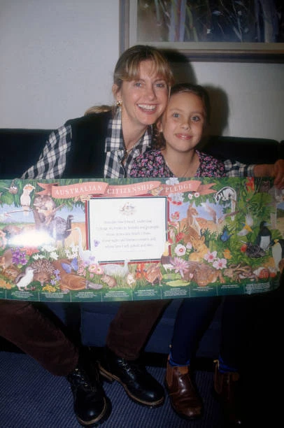 OLIVIA NEWTON-JOHN WITH her daughter Chloe holding an Australian C ...