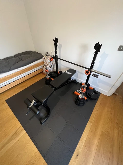 MIRAFIT HOME GYM setup with a bench, olympic barbell and dumbells £200. ...