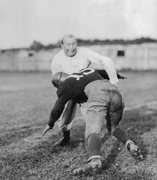 NOTRE DAME COACH Knute Rockne tackled by one players during pra- 1926 ...
