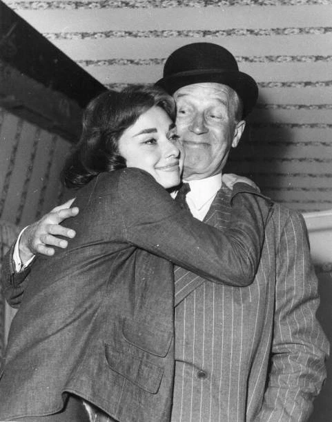 BRITISH DUTCH ACTRESS Audrey Hepburn embracing French singer ac- 1956 ...