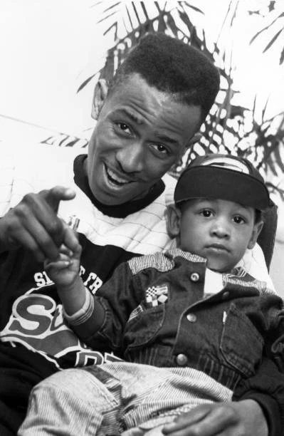 RAPPER MC SHAN poses for a portrait with his son, Little Shan, in - Old ...